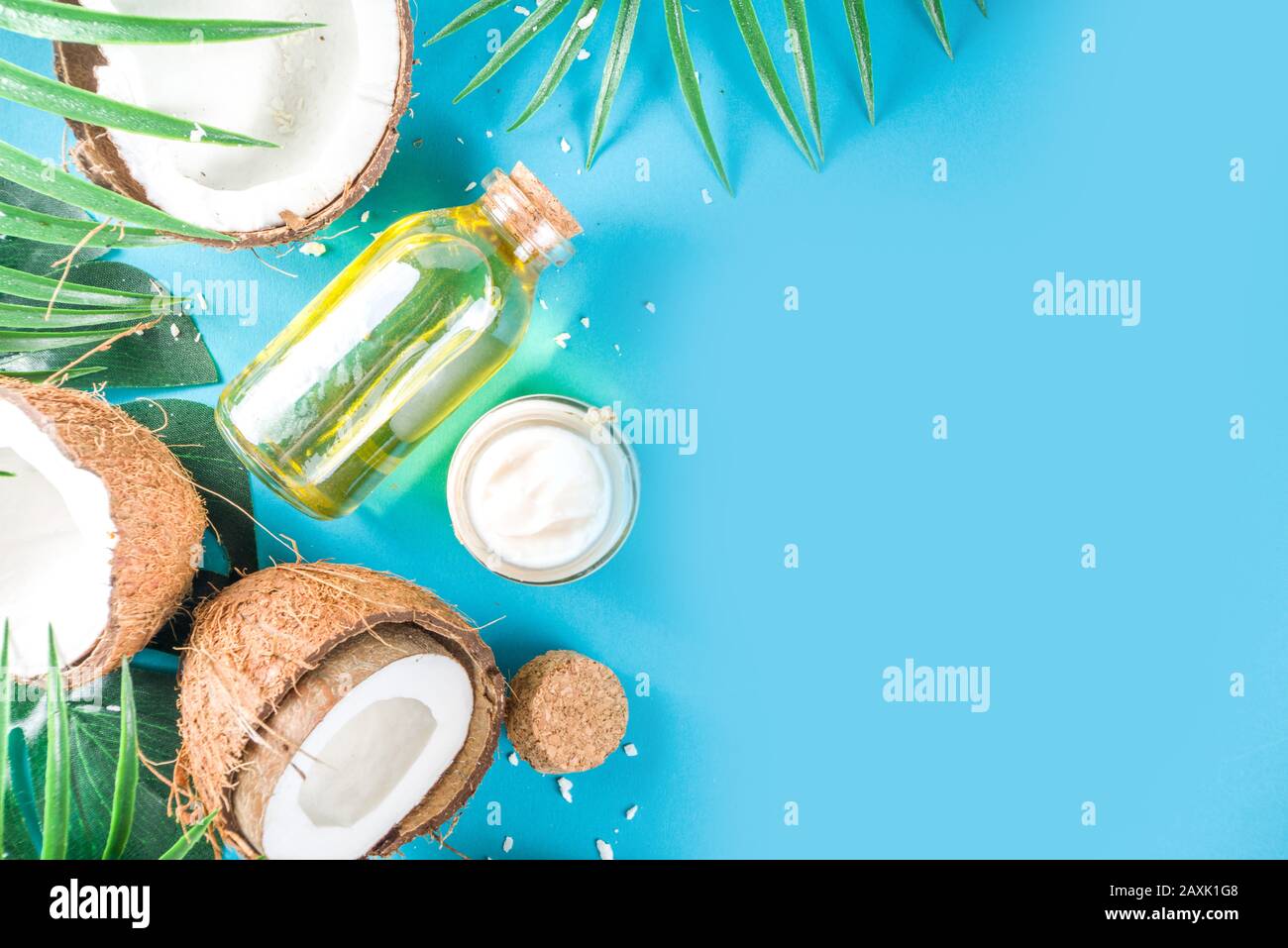 Coconut oil in glass jar with tropical leaves and fresh coconut ...