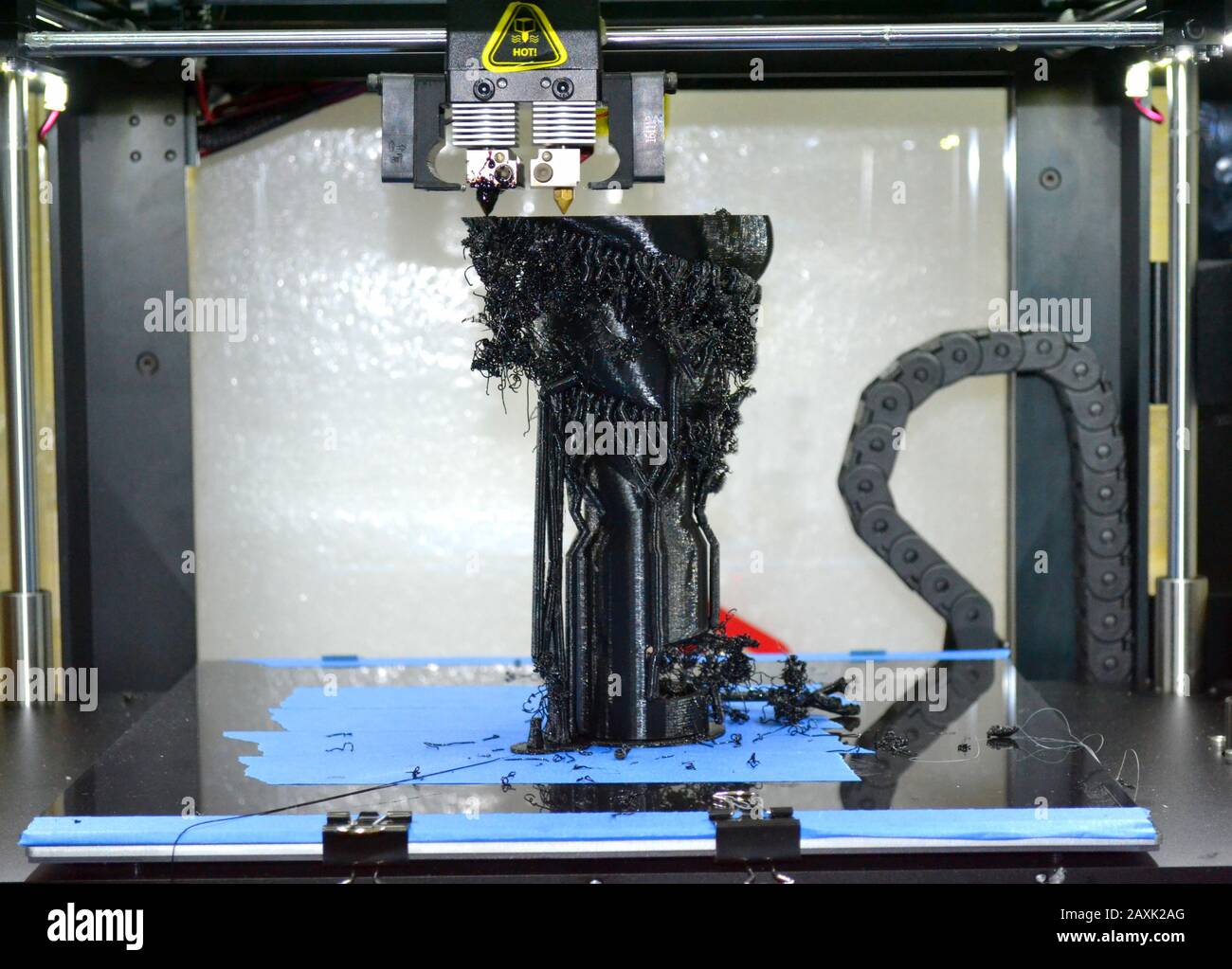 3d printer printing black shapes close-up. Image of automatic three ...