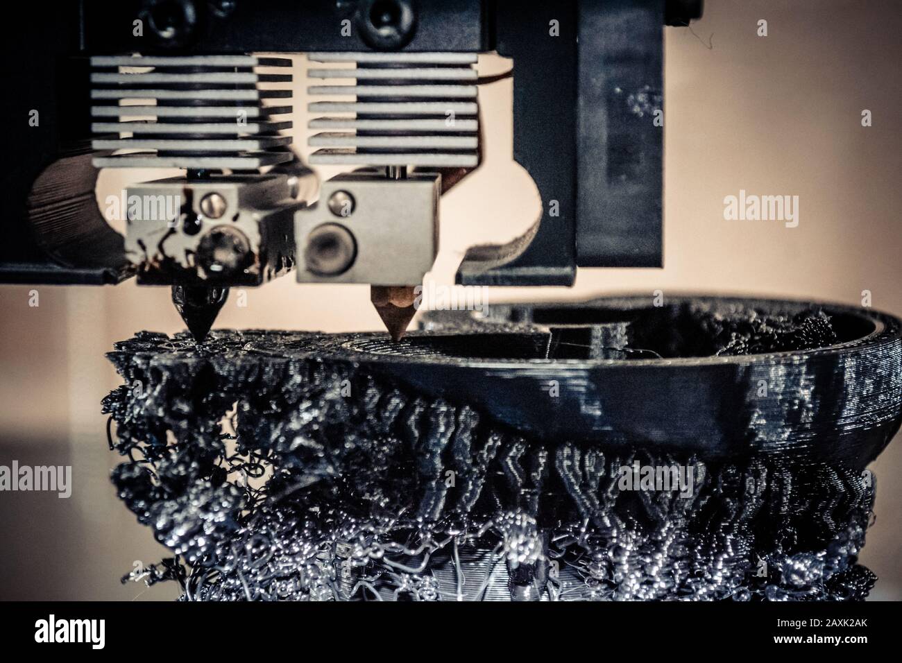 3d printer printing black shapes close-up. Image of automatic three ...