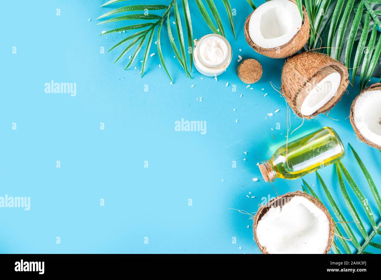 Coconut oil in glass jar with tropical leaves and fresh coconut ...