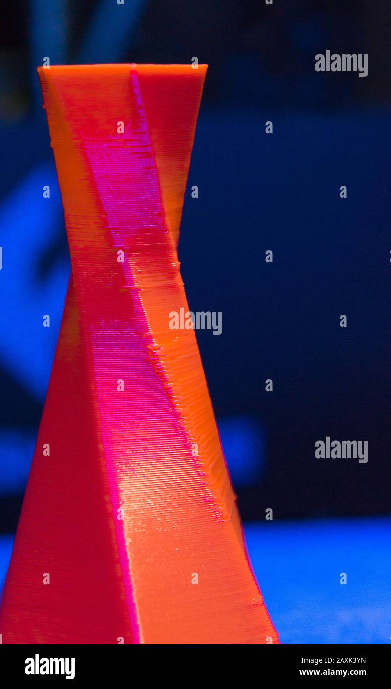 3D printer printing isolated volume triangular object red color on the ...