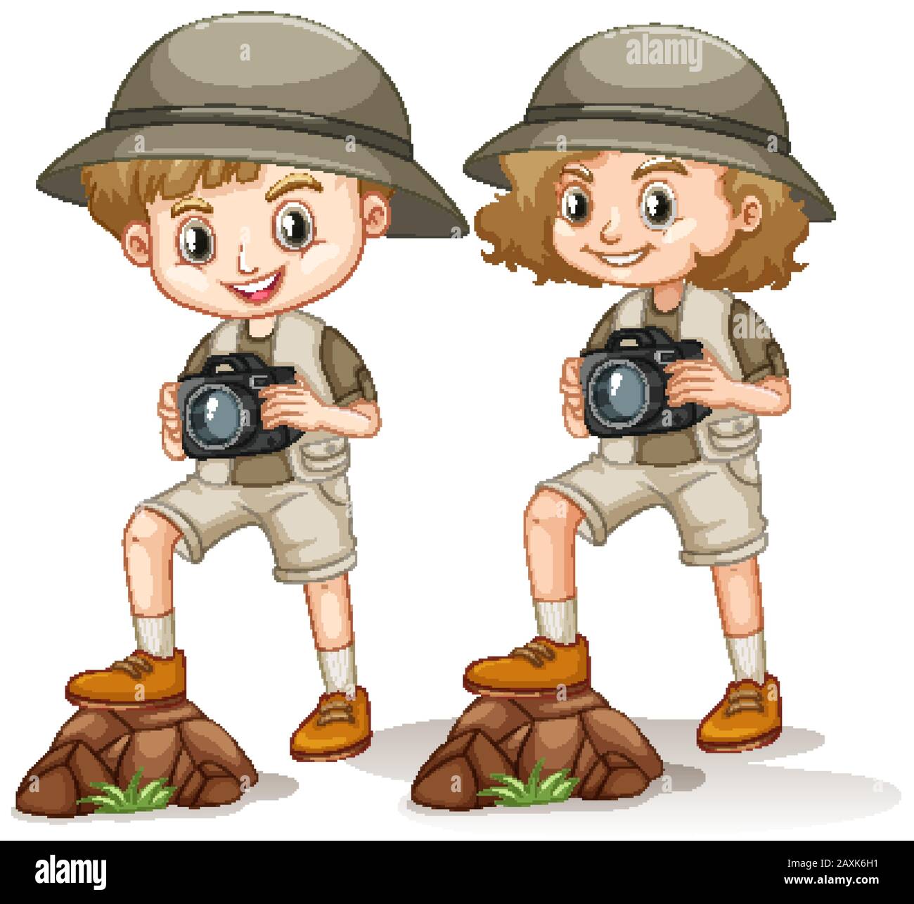 Boy and girl in safari outfit with camera standing on the rock ...