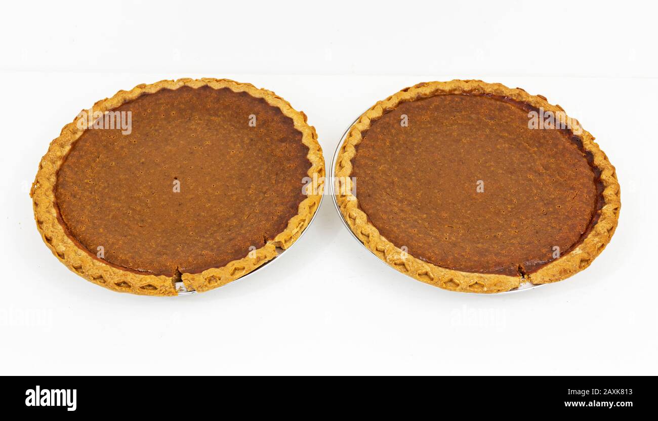 Two pumpkin pies side by side with a white background Stock Photo - Alamy