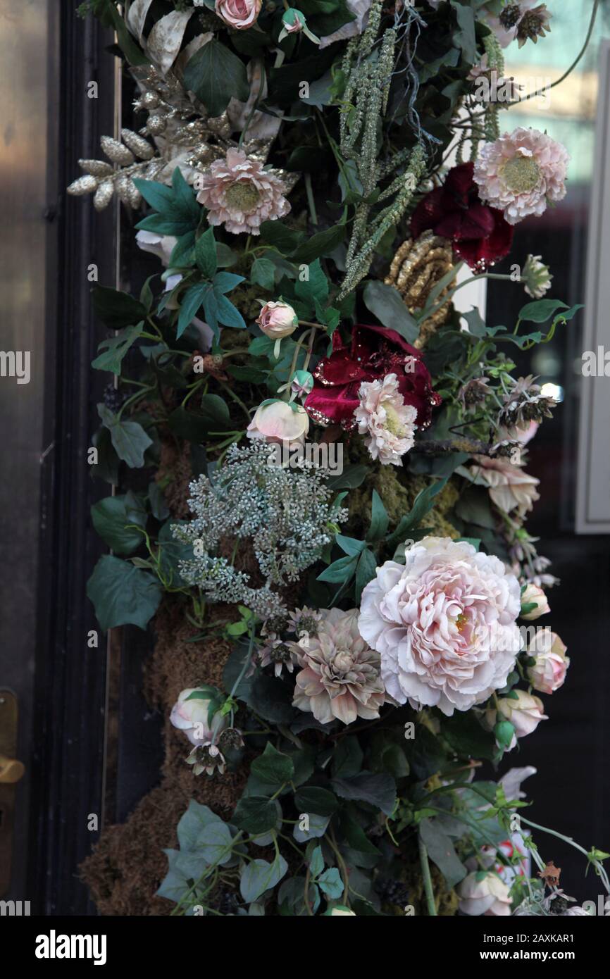Flowers surround door frame as vertical garden in Esher, Surrey, UK ...