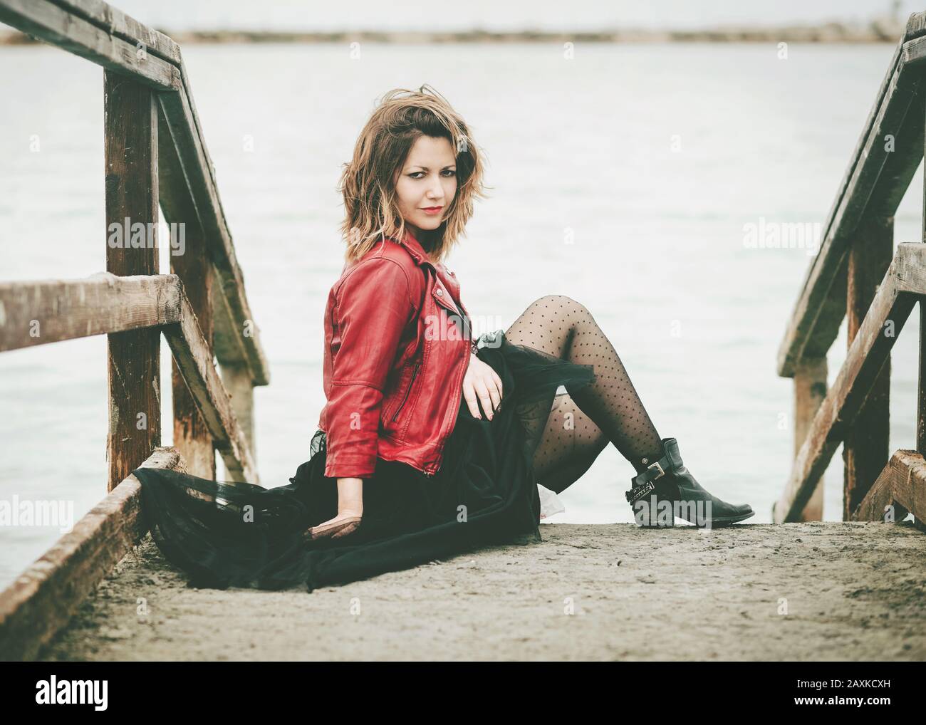 Young woman sitting outdoor hi-res stock photography and images - Alamy