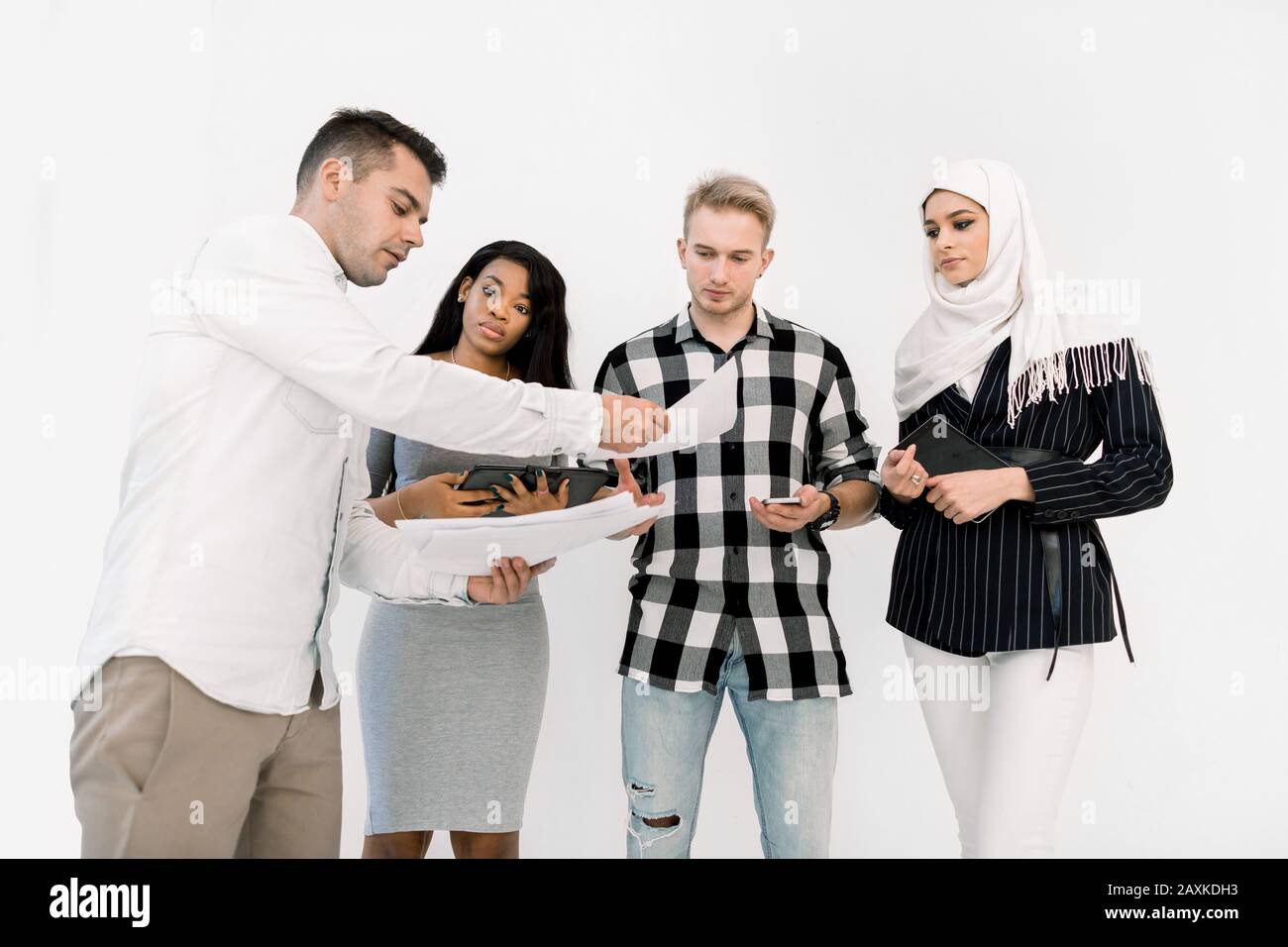Four Multicultural College students friends, male and female, standing ...