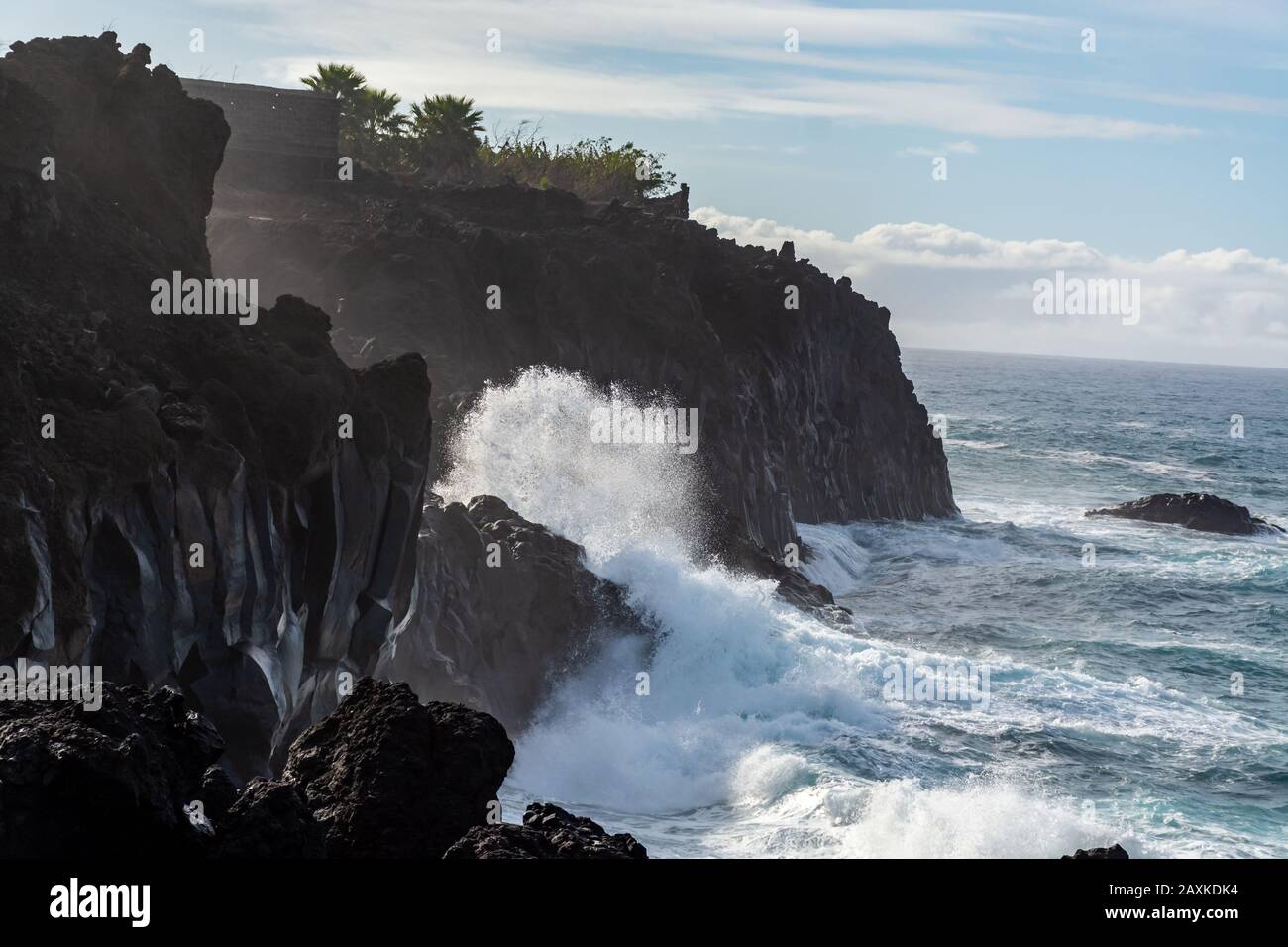 Dangerious ocean stormy waves hits black lava rocks on La Palma island ...