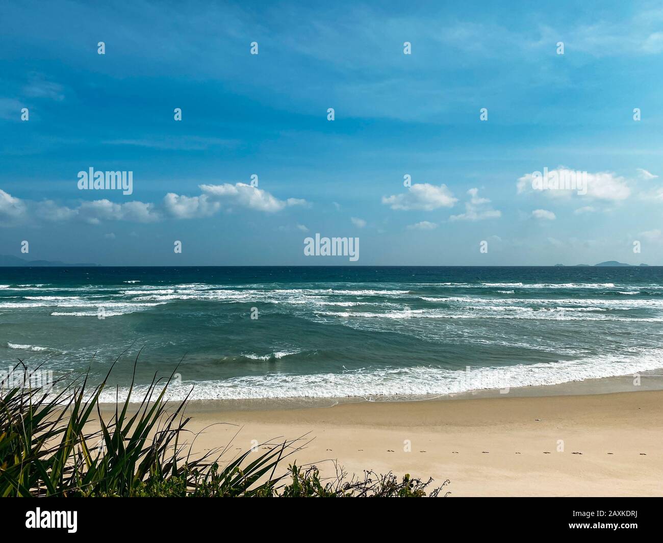 Sandy seashore, calm soft waves at sea, sunny weather, blue sky with ...