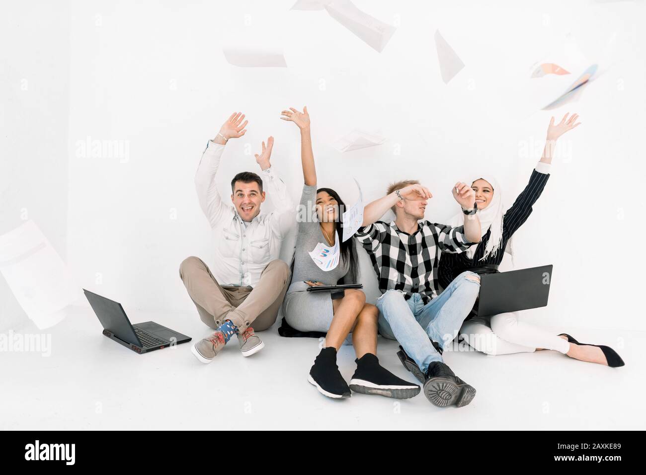 Business winners, final exam passed. Multiracial group of cheerful ...