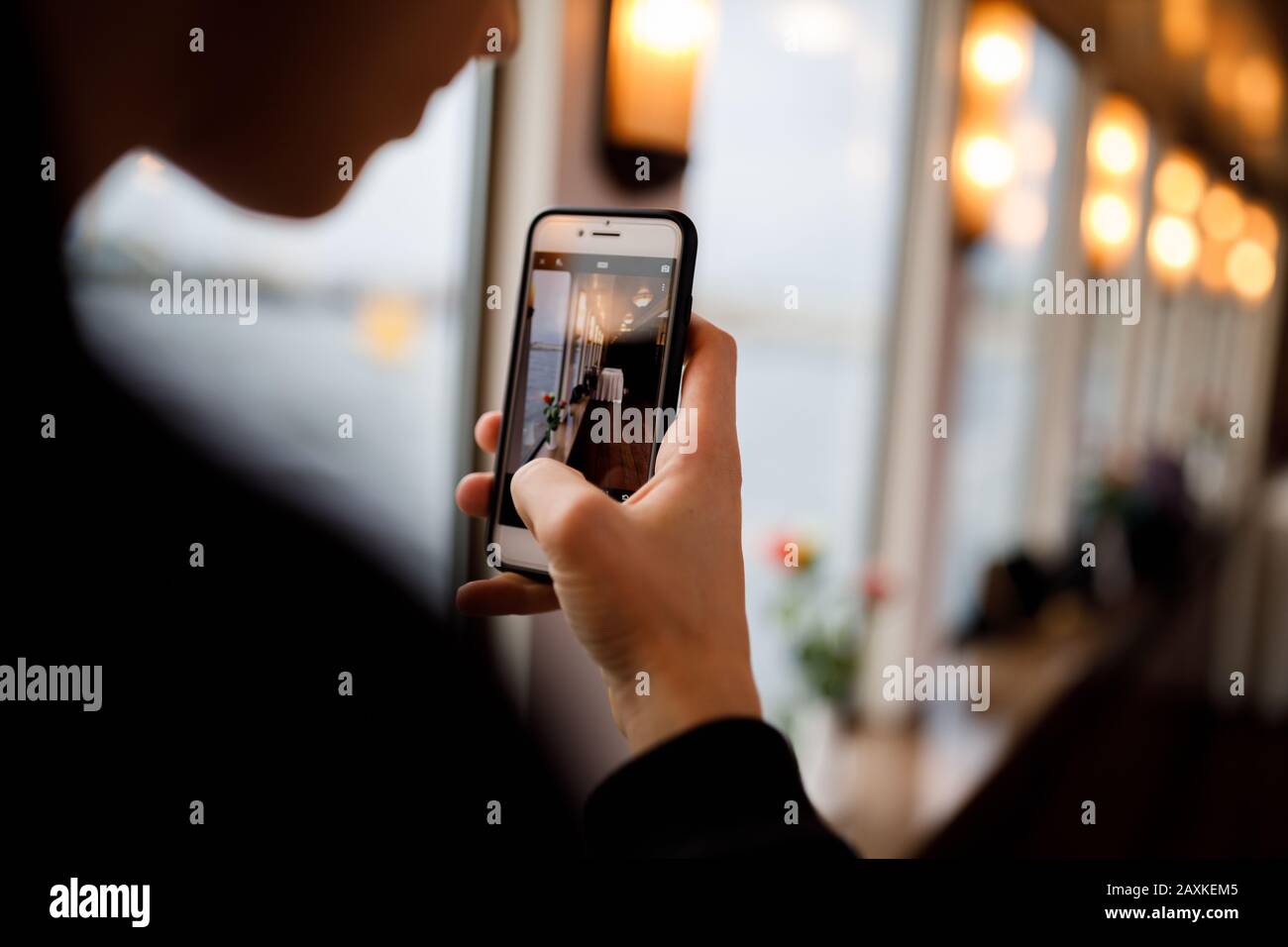 Young boy taking a photo with a phone Stock Photo - Alamy