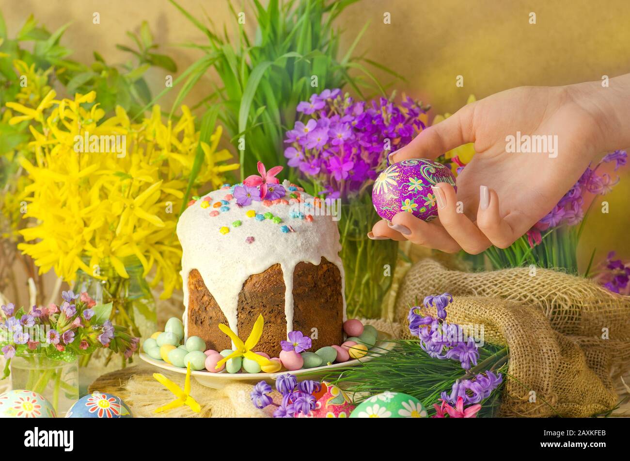 Traditional Easter cake paska. Woman hands holding easter egg. Table ...