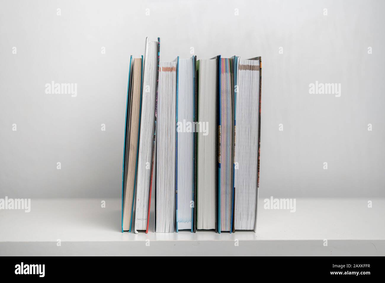simple stack of books on the shelf at home Stock Photo - Alamy