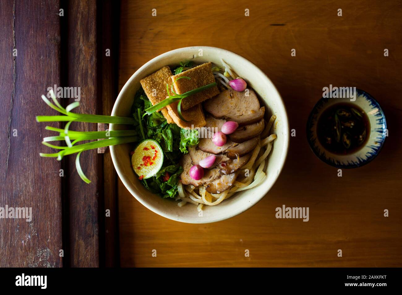 High angle close up of bowl of Cao lau noodles, a specialty dish with ...