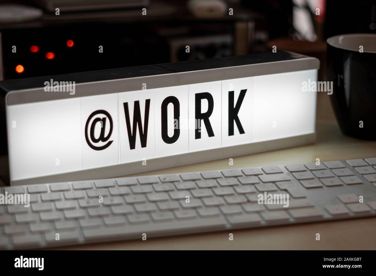 on a white illuminated cinema sign with black letters @WORK Stock Photo ...