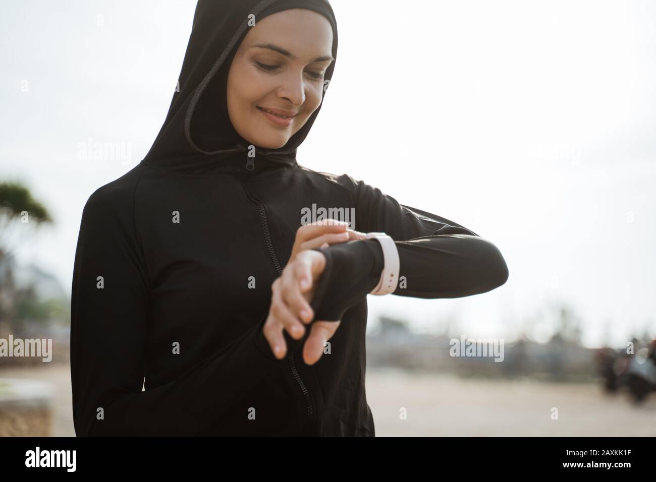 Sport watch run muslim woman checking smartwatch tracker. female runner ...
