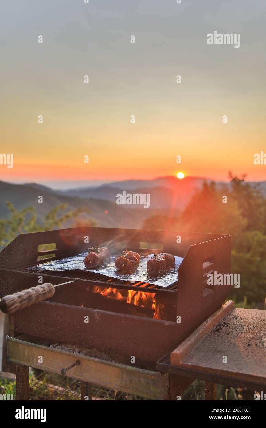 Barbecue grill with fire on nature Stock Photo - Alamy