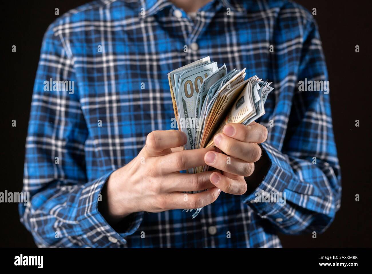 a person standing against the color wall and counting the bunch of ...