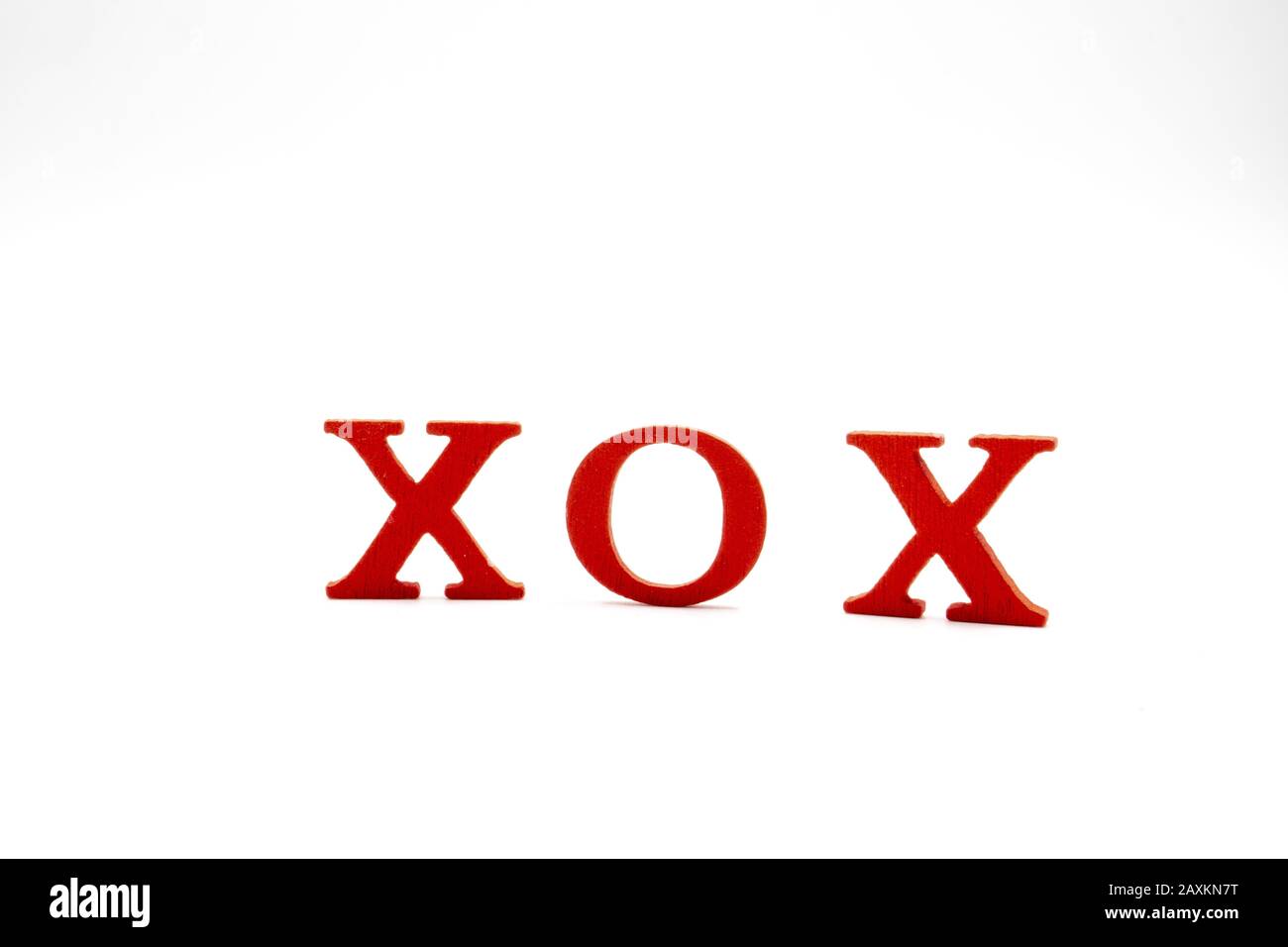 Photo of red letter blocks spelling out "xox" isolated on white ...