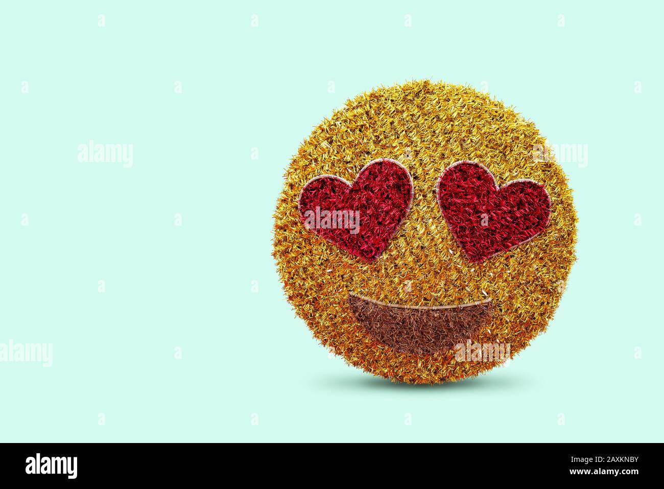 Yellow and red colered face shape emoticon, showing love feeling ...