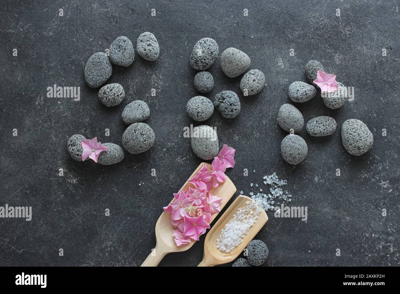 dark Spa background with pebbles and flowers Stock Photo - Alamy