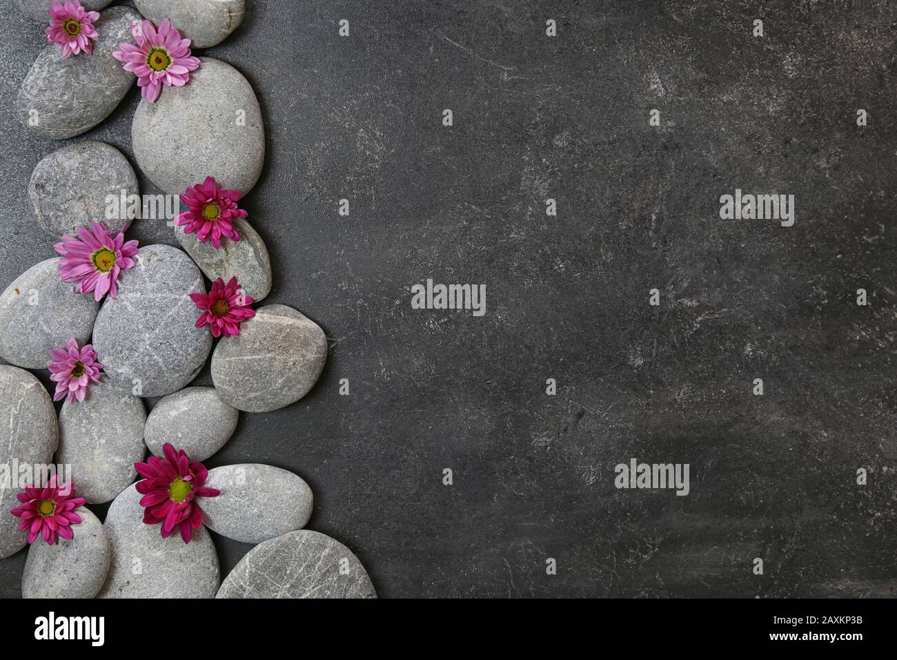 dark Spa background with pebbles and flowers Stock Photo - Alamy