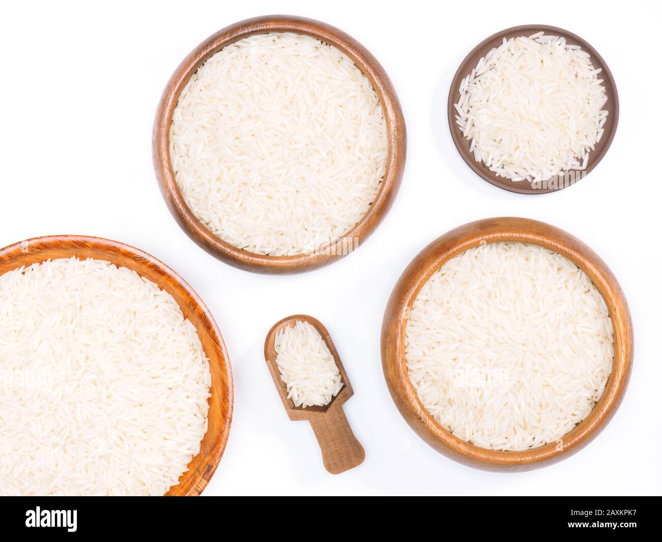 Indian long grain Basmati rice in wooden bowls and scoop on white ...