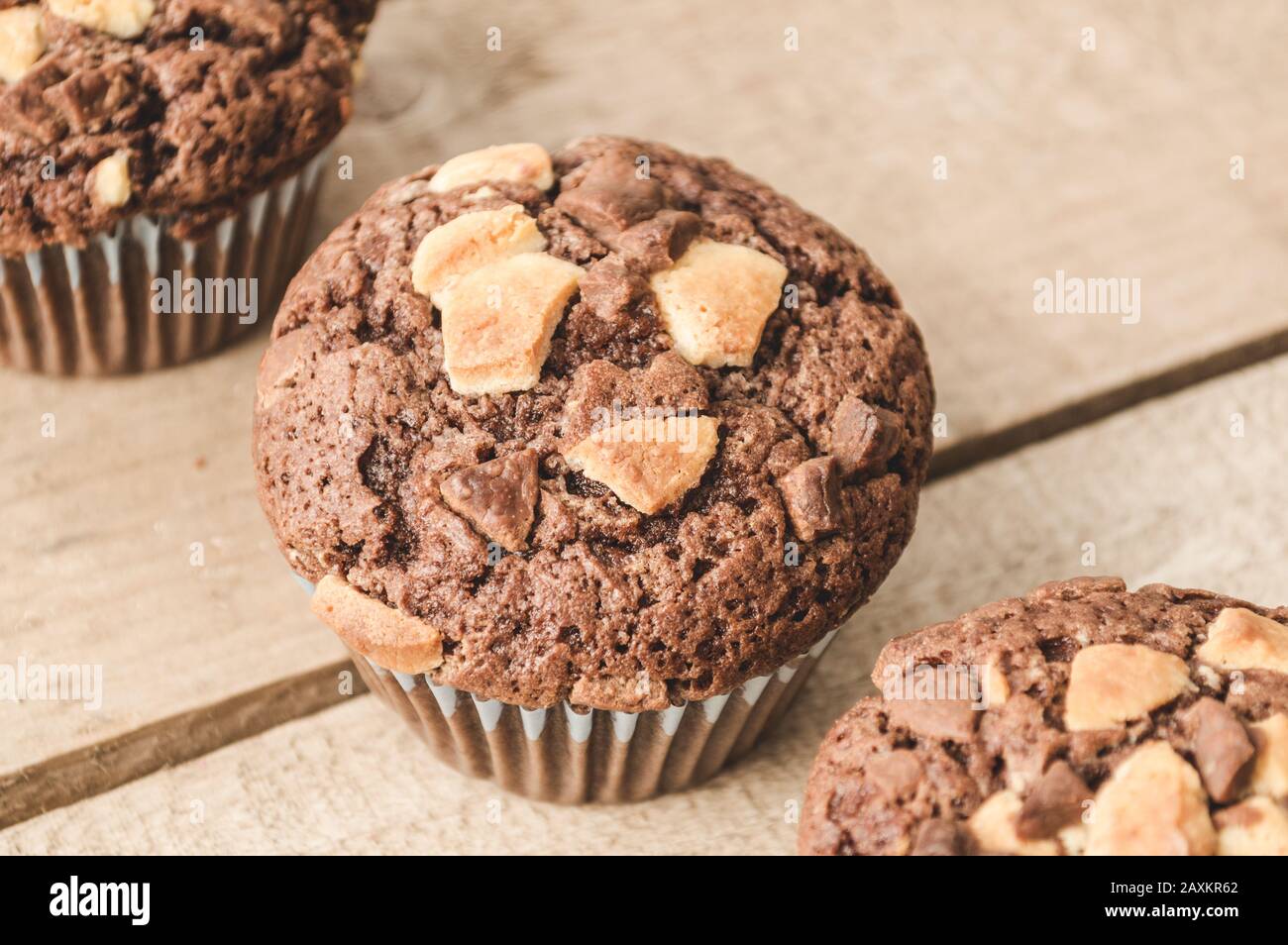 Three chocolate muffins lined up diagonally Stock Photo - Alamy