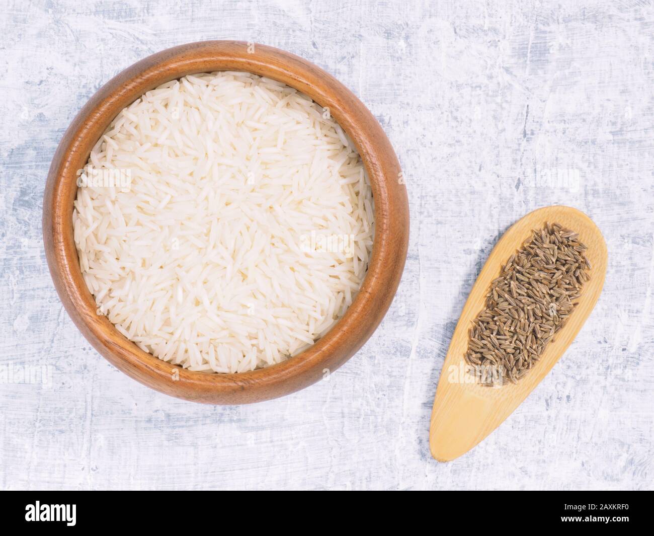 Indian long grain Basmati rice in brown wooden bowl and cumin (jeera ...