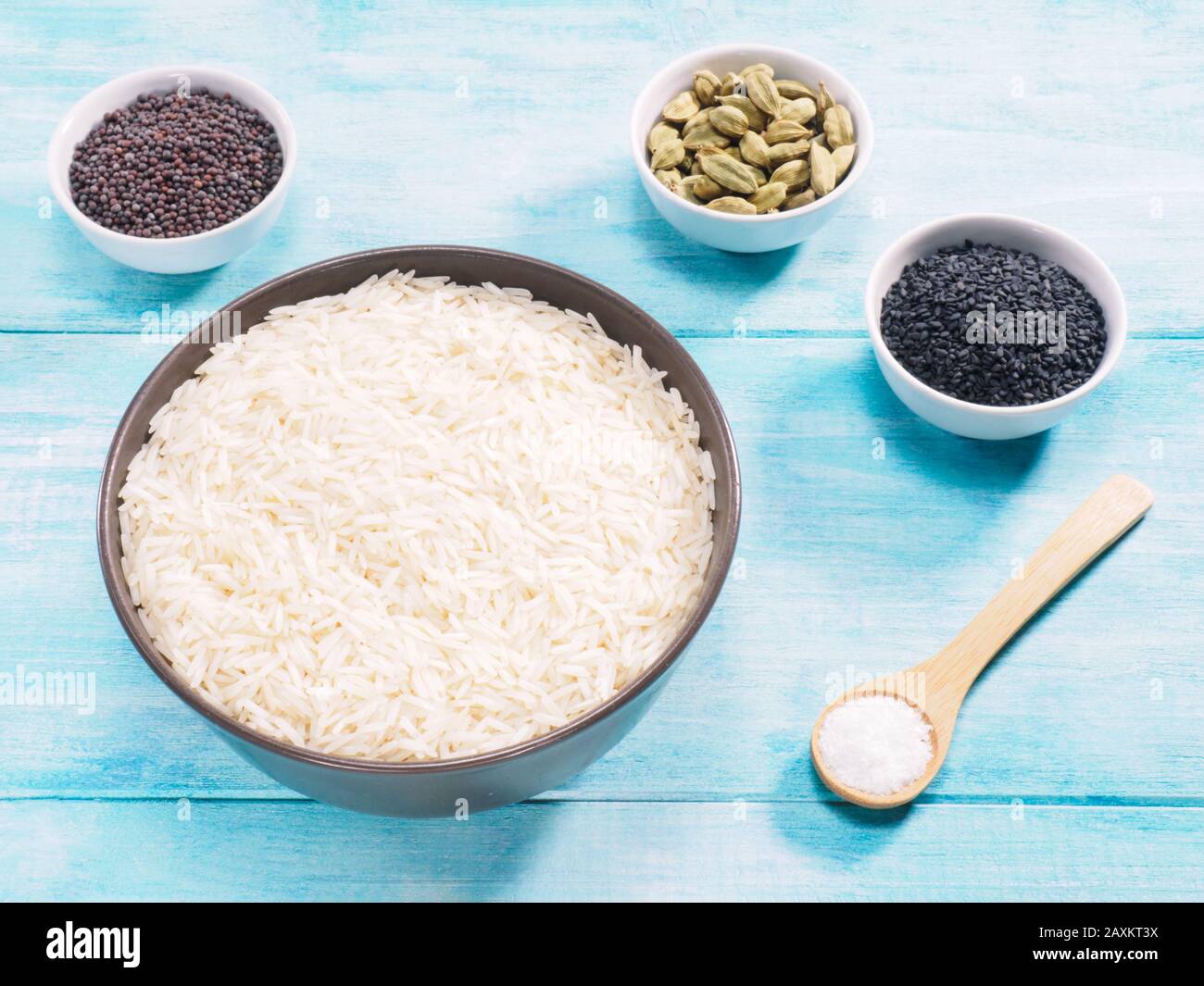 Long grain Basmati rice in brown ceramic bowl, black cumin, green ...