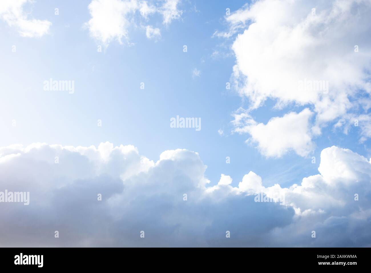 Blue sky with clouds and sunlight in daylight, soft bright background Stock Photo - Alamy