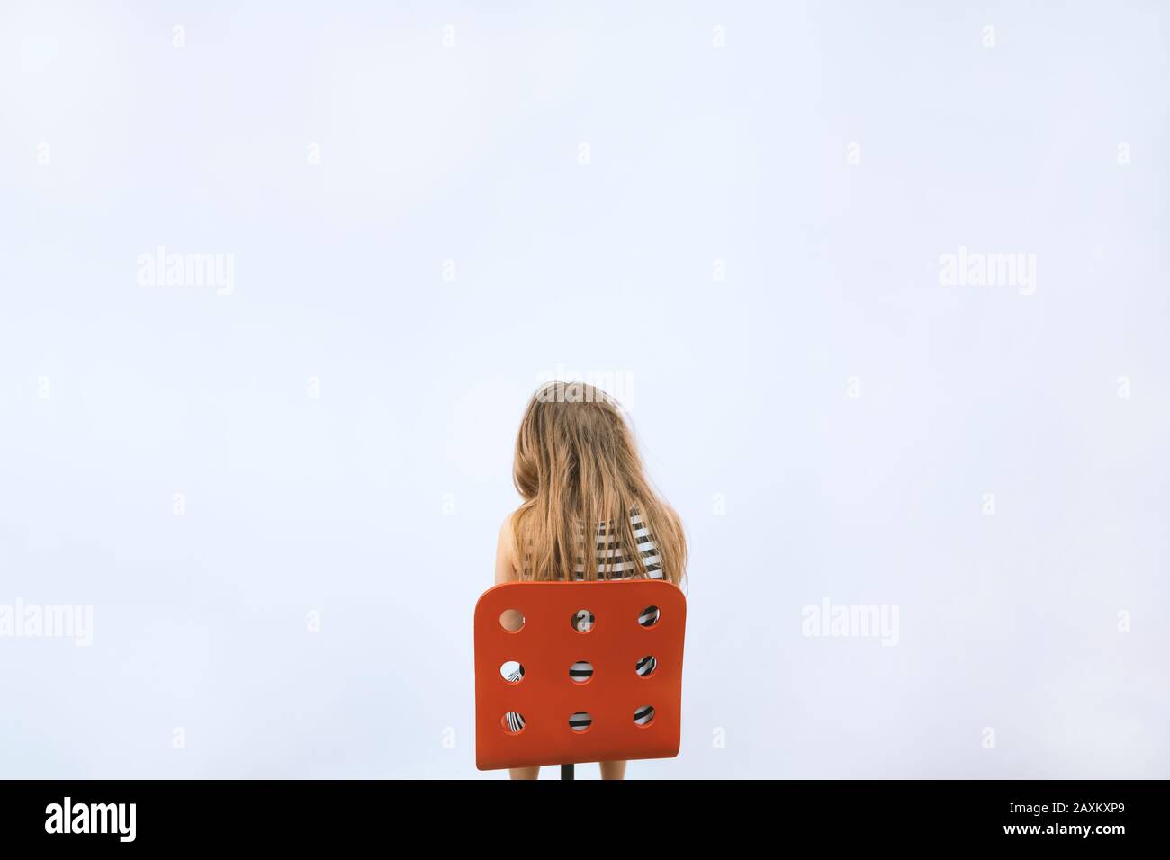 Girl sitting on red chair. Mental health concept. Teenager in ...