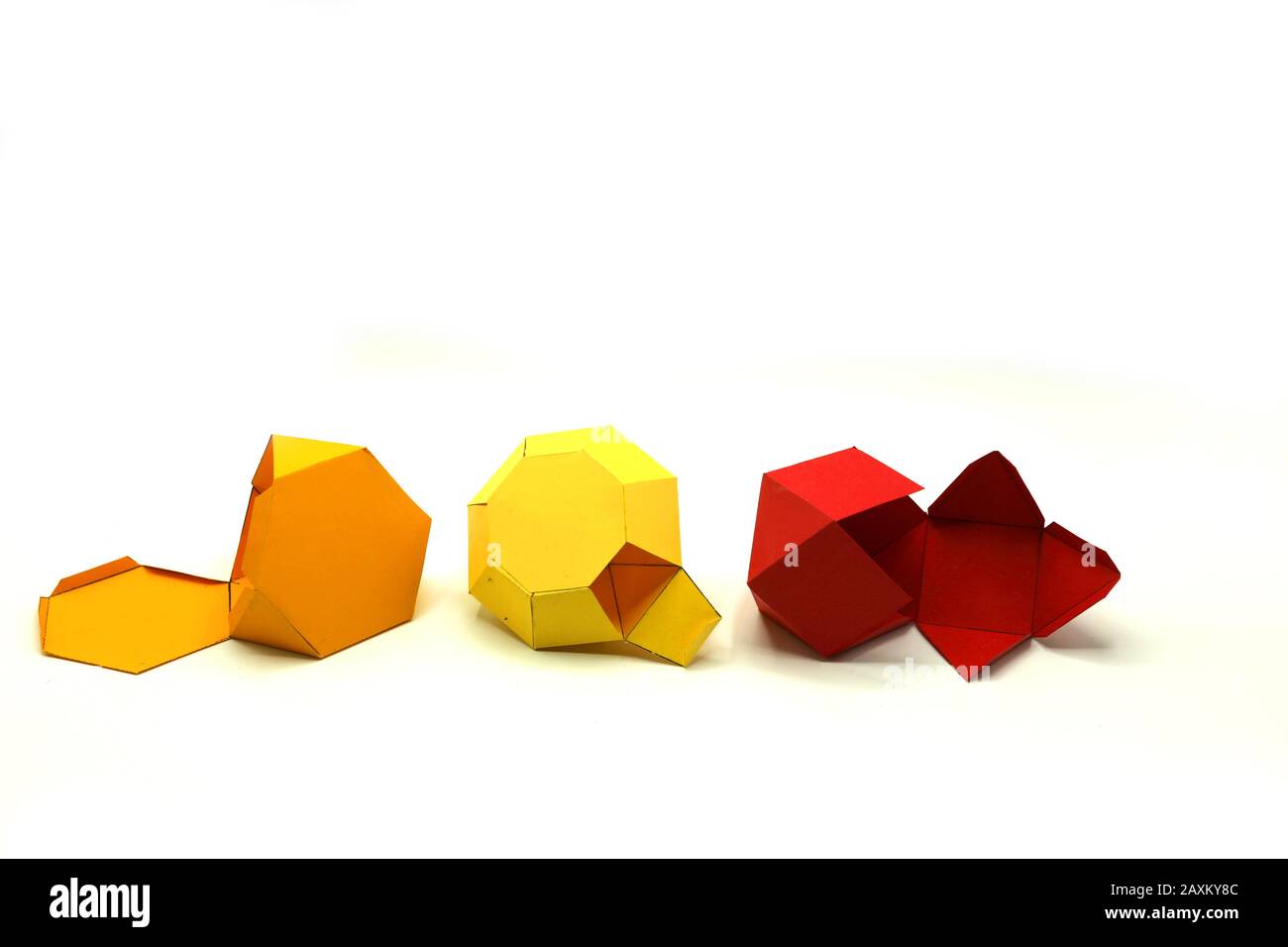 Geometric shapes cut out of colored paper and photographed on white ...