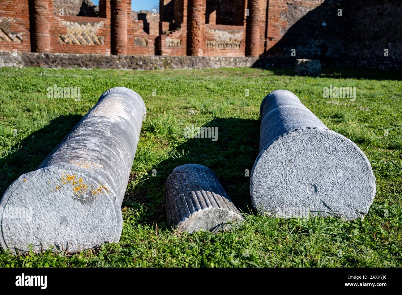 Ancient Roman pillars lying on the grass at Pompeii a UNESCO world ...