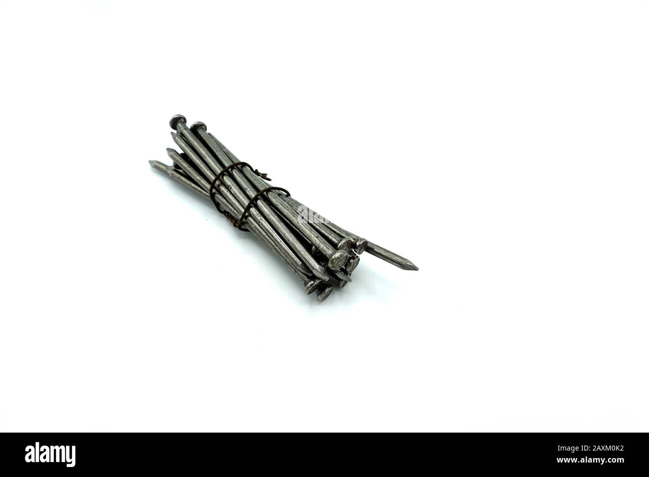 Steel construction nails of different lengths tied together in groups ...