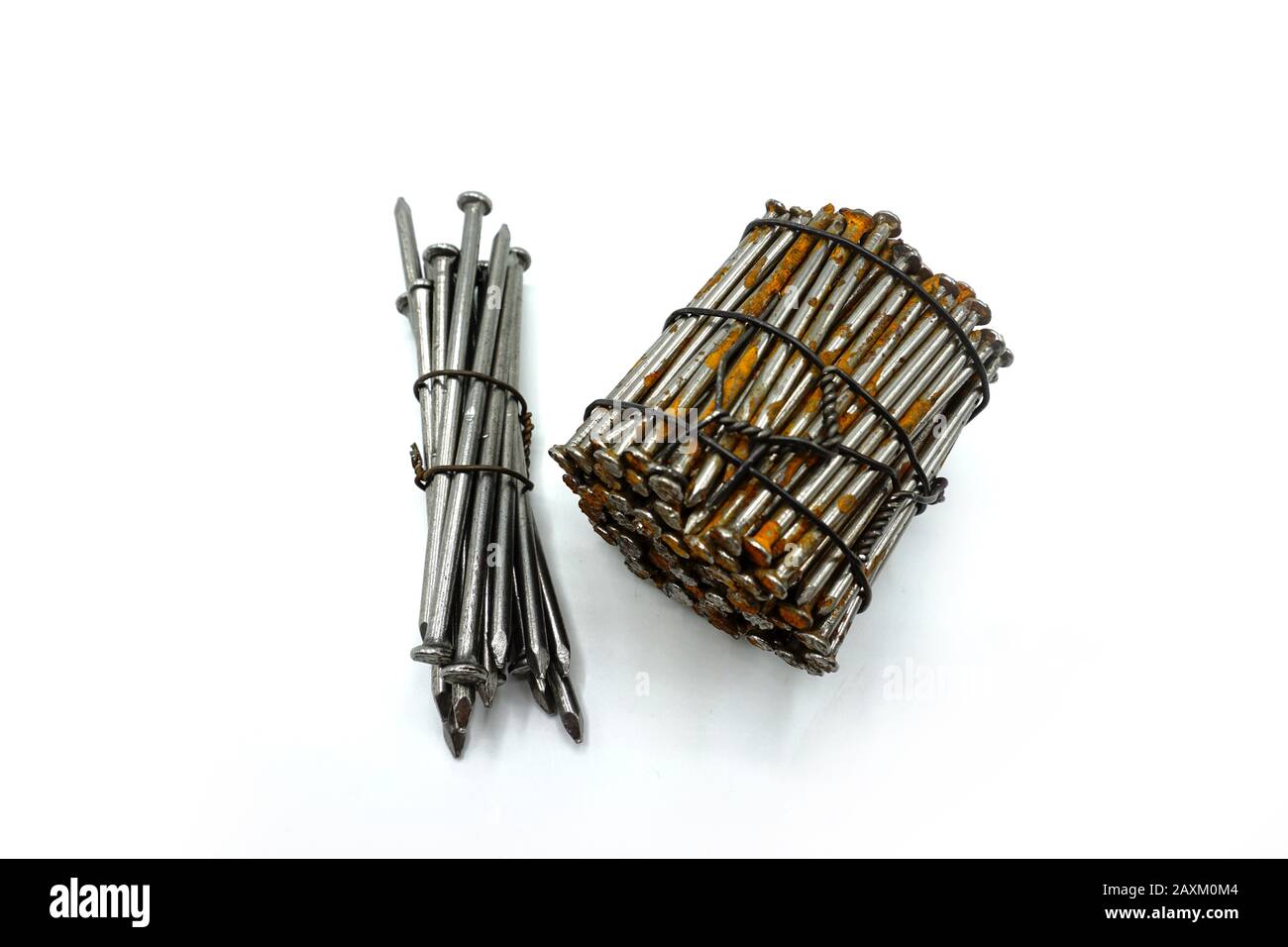 Steel construction nails of different lengths tied together in groups ...