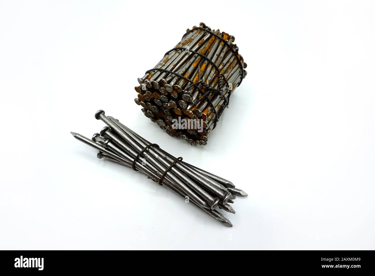 Steel construction nails of different lengths tied together in groups ...