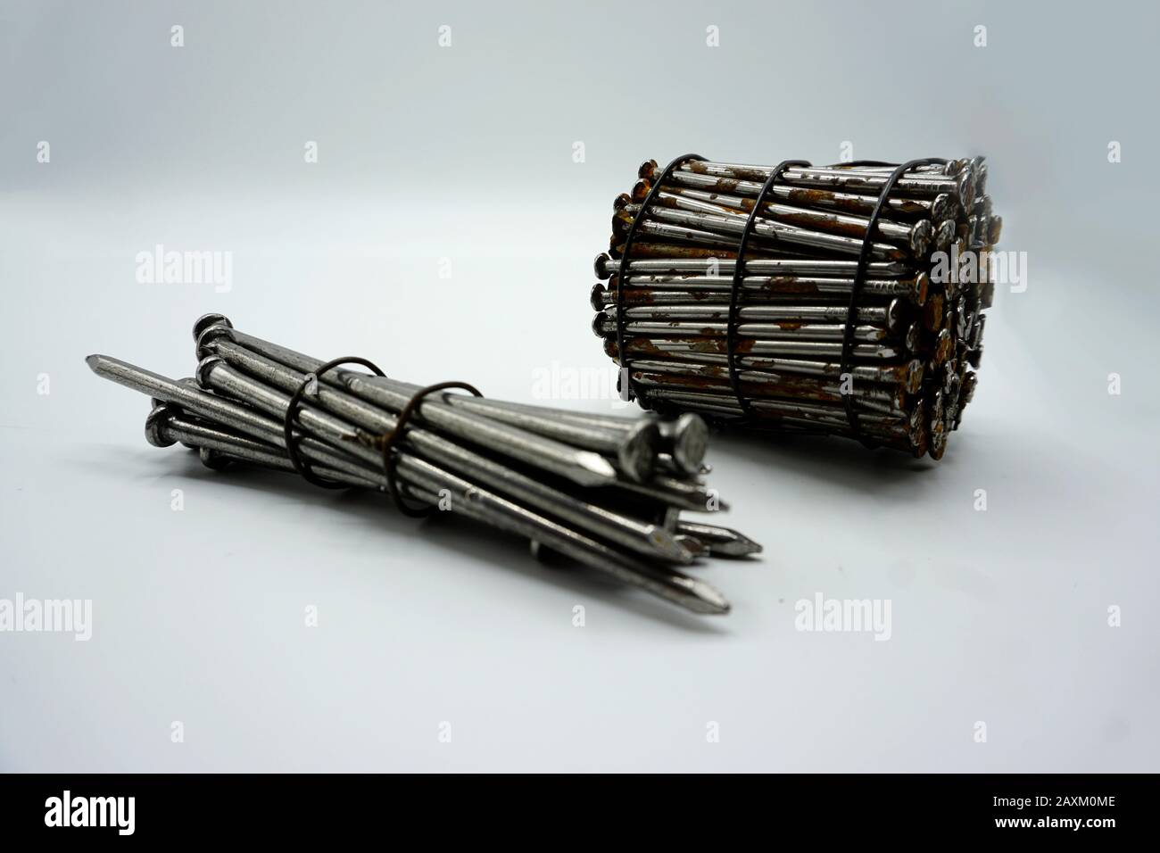Steel construction nails of different lengths tied together in groups ...