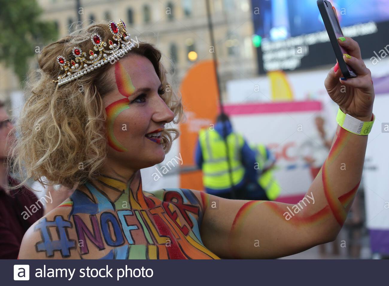 A woman with the words no filter on her body takes a selfie at the ...