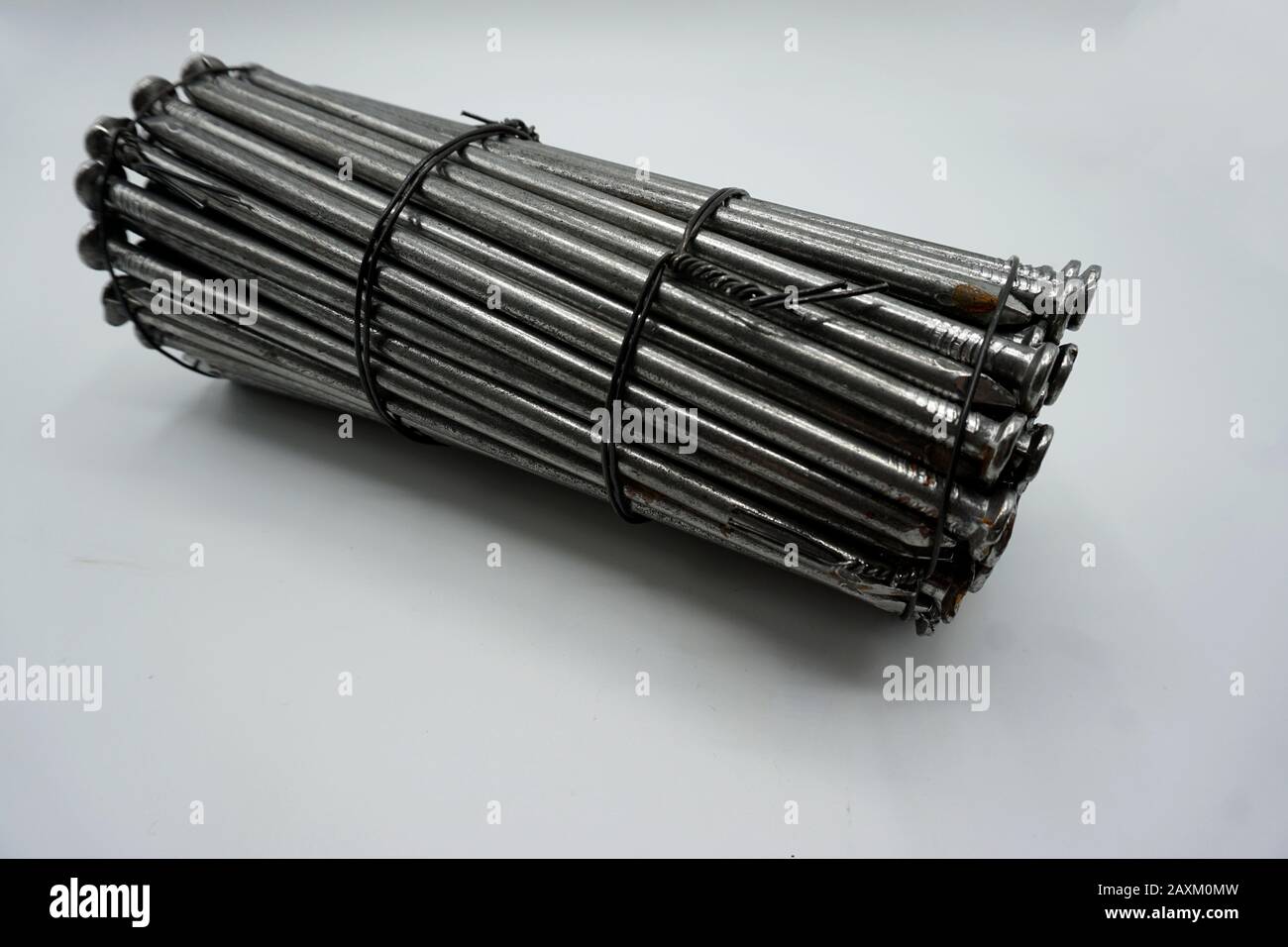 Steel construction nails of different lengths tied together in groups ...