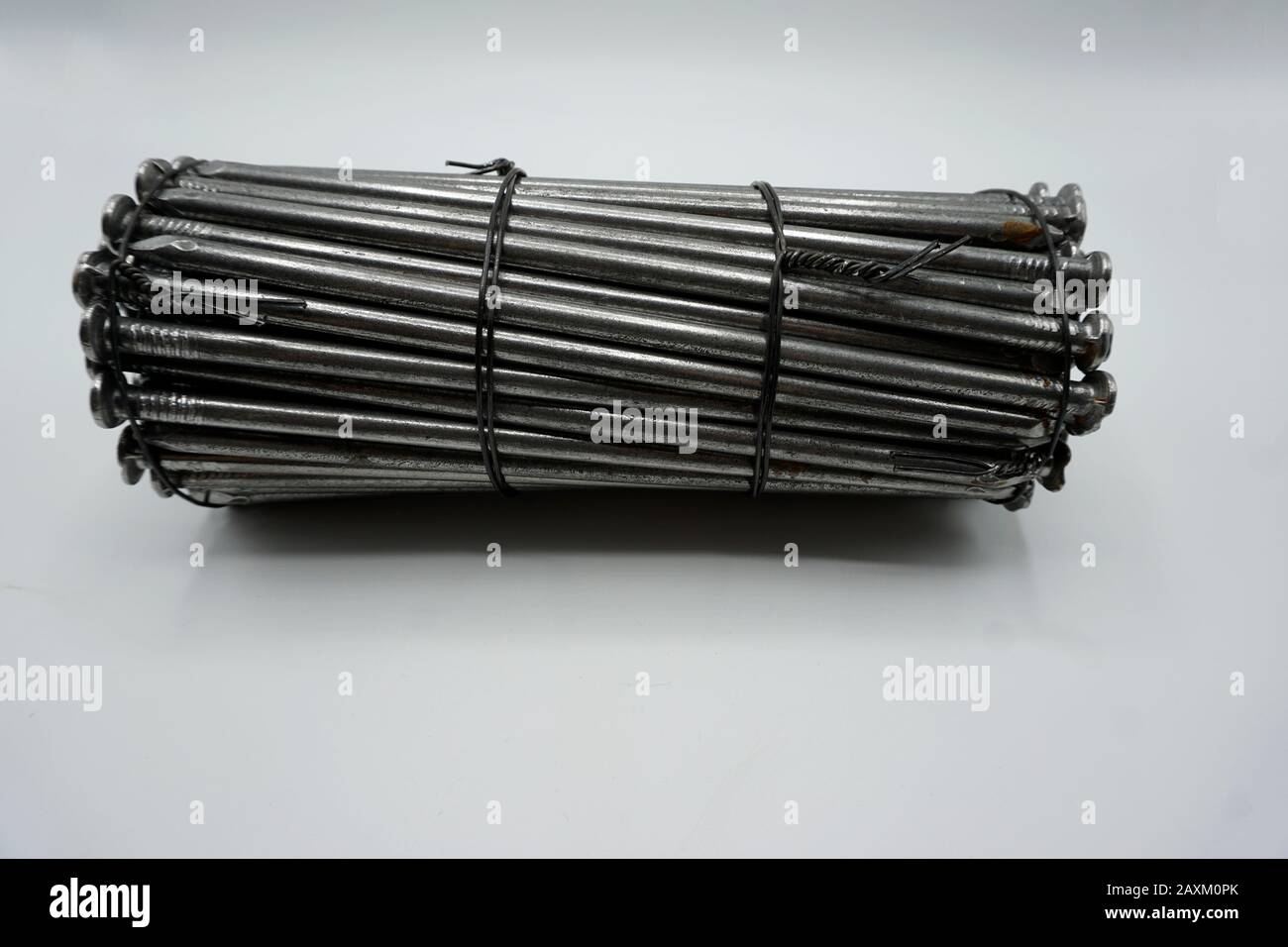 Steel construction nails of different lengths tied together in groups ...