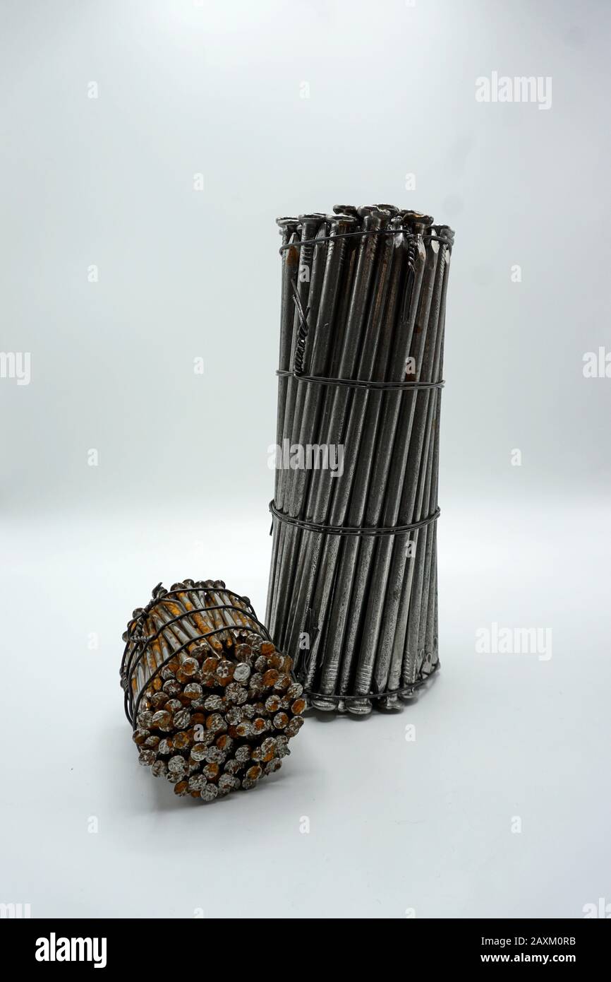 Steel construction nails of different lengths tied together in groups ...