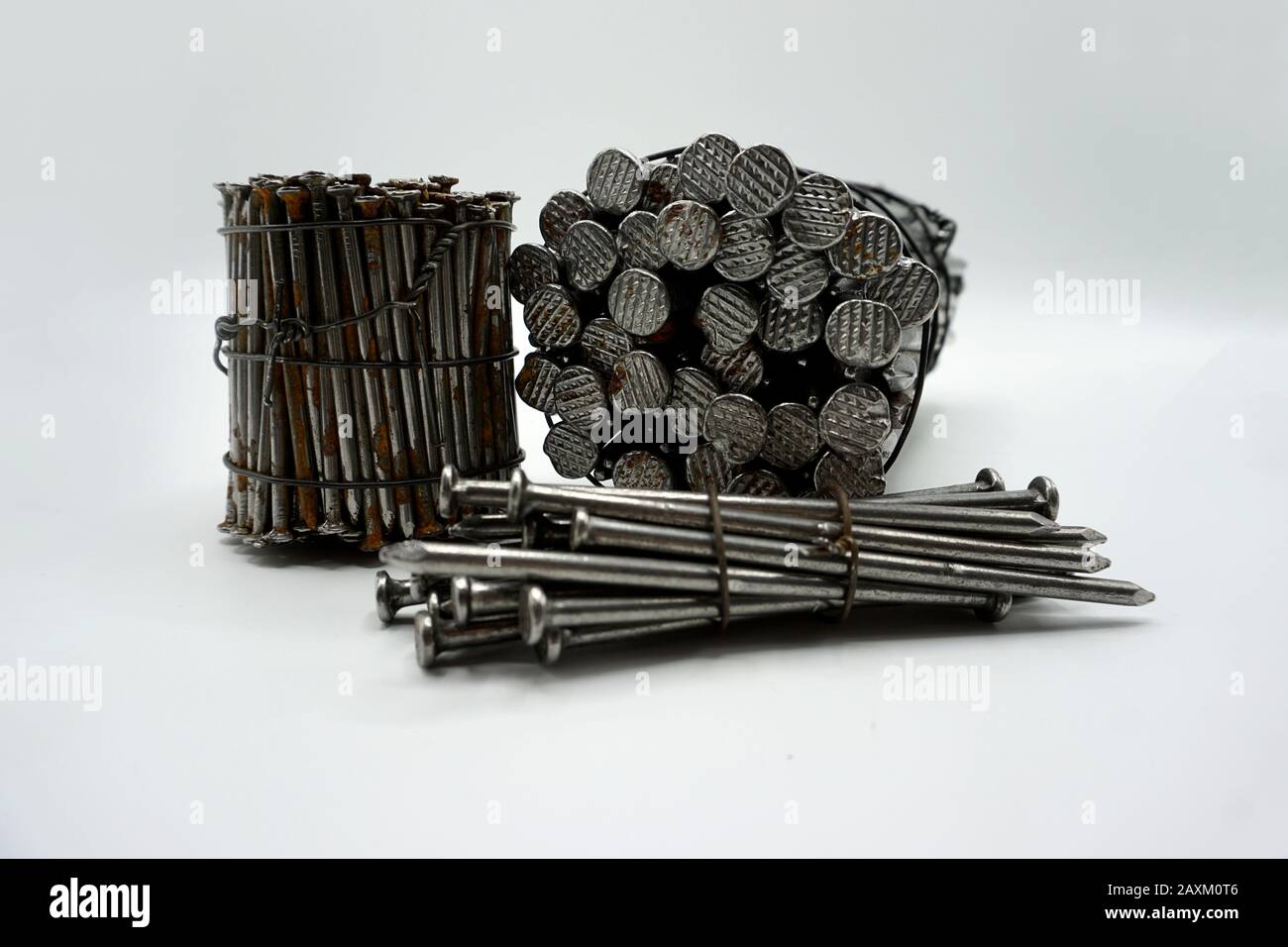 Steel construction nails of different lengths tied together in groups ...