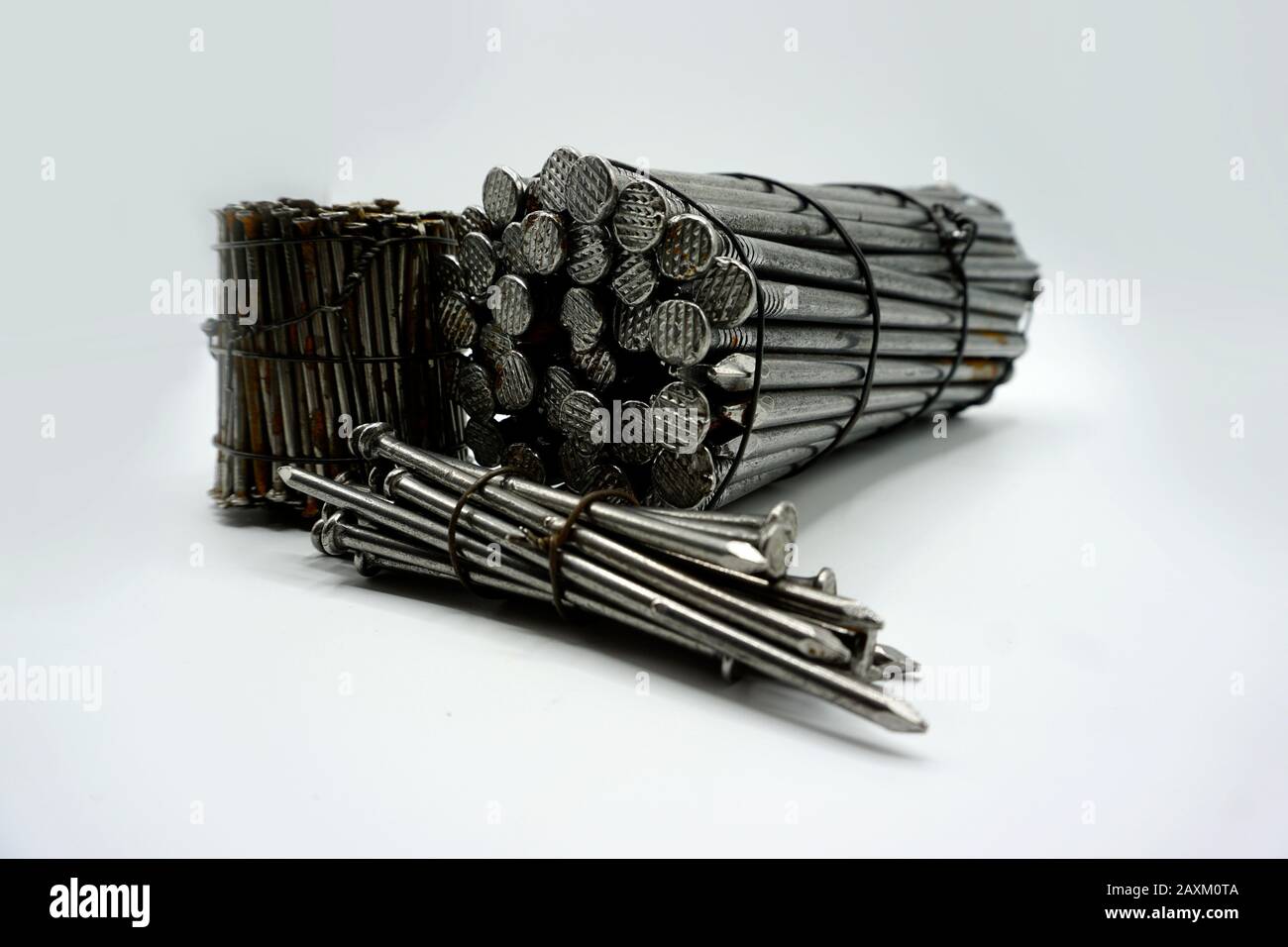 Steel construction nails of different lengths tied together in groups ...