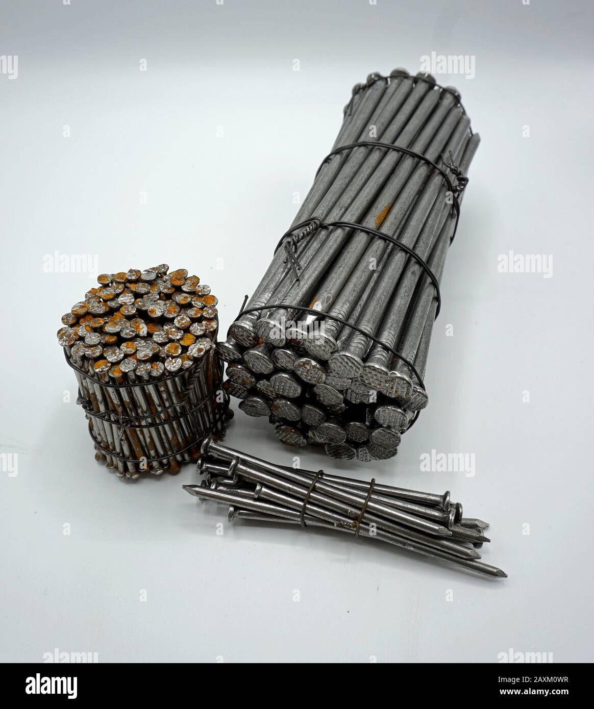 Steel construction nails of different lengths tied together in groups ...