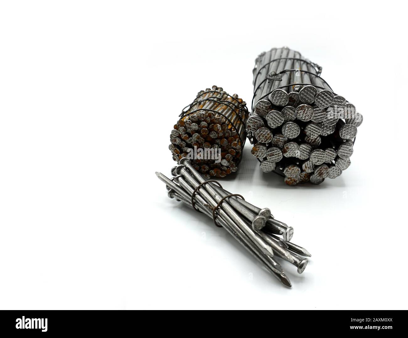 Steel construction nails of different lengths tied together in groups ...