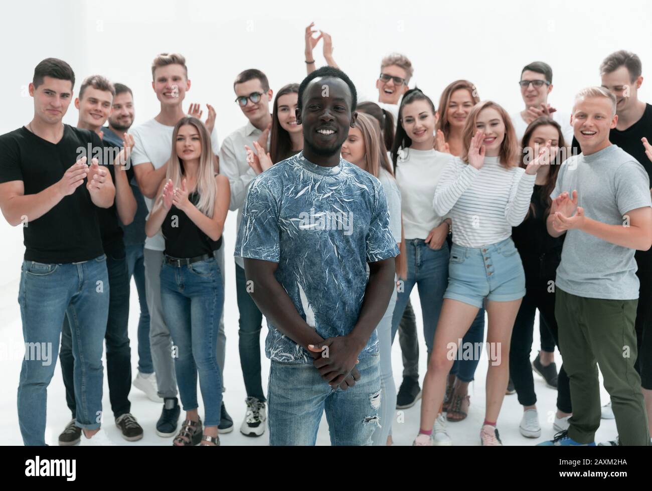 happy guy standing among a group of his friends Stock Photo - Alamy