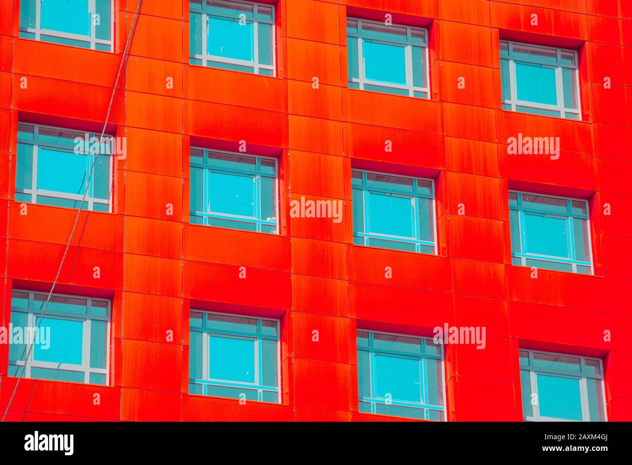 abstract facade of a modern building. Red square windows with blue ...