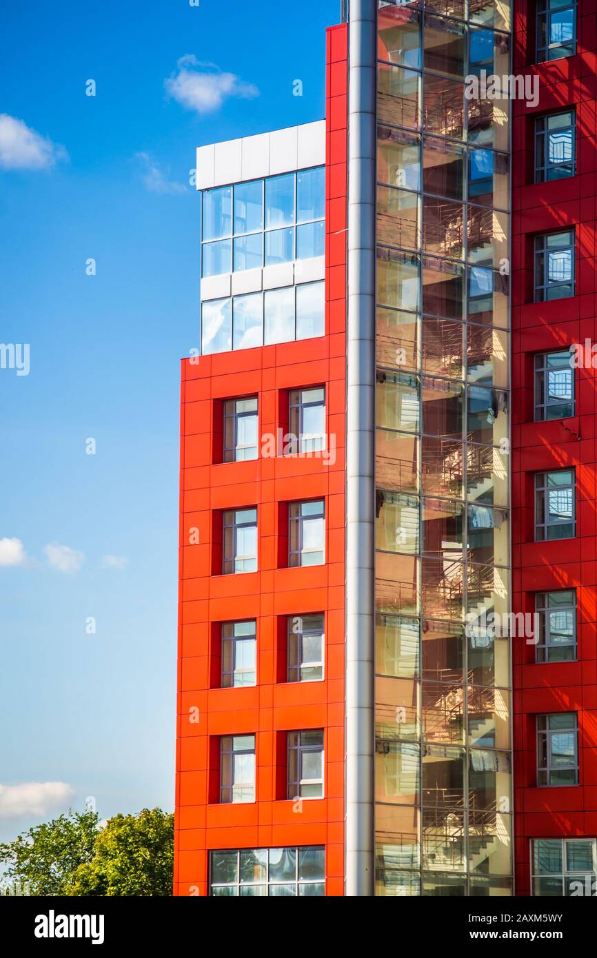 modern building with a red square windows and mirrored glass on the ...