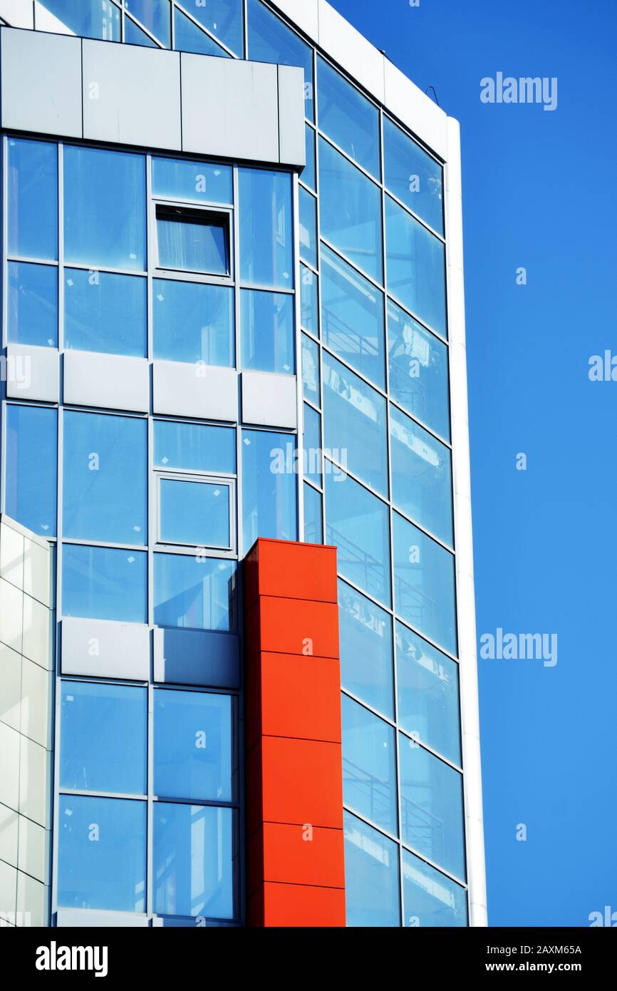 Red blue modern building facade of a bright sunny day with clear sky ...