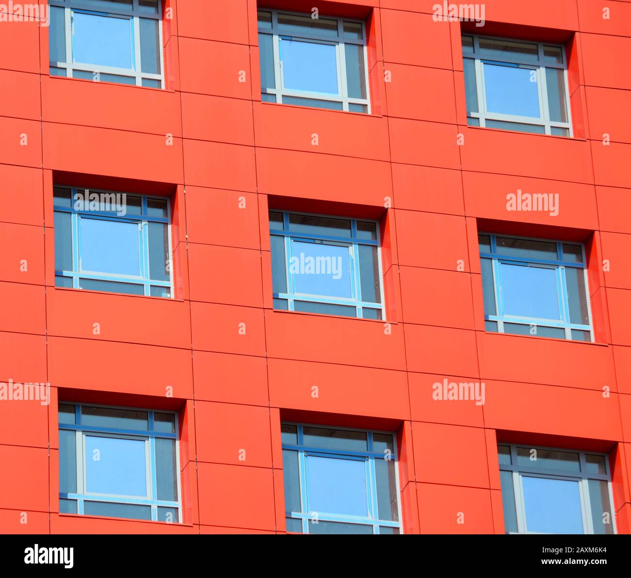 abstract facade of a modern building. Red square windows with blue ...